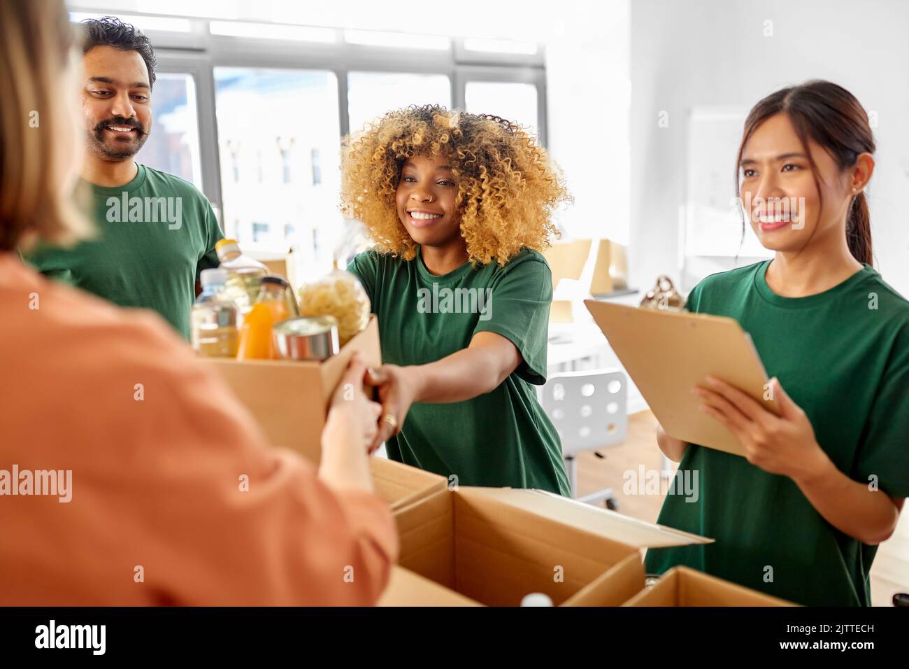 happy volunteers packing food in donation boxes Stock Photo - Alamy