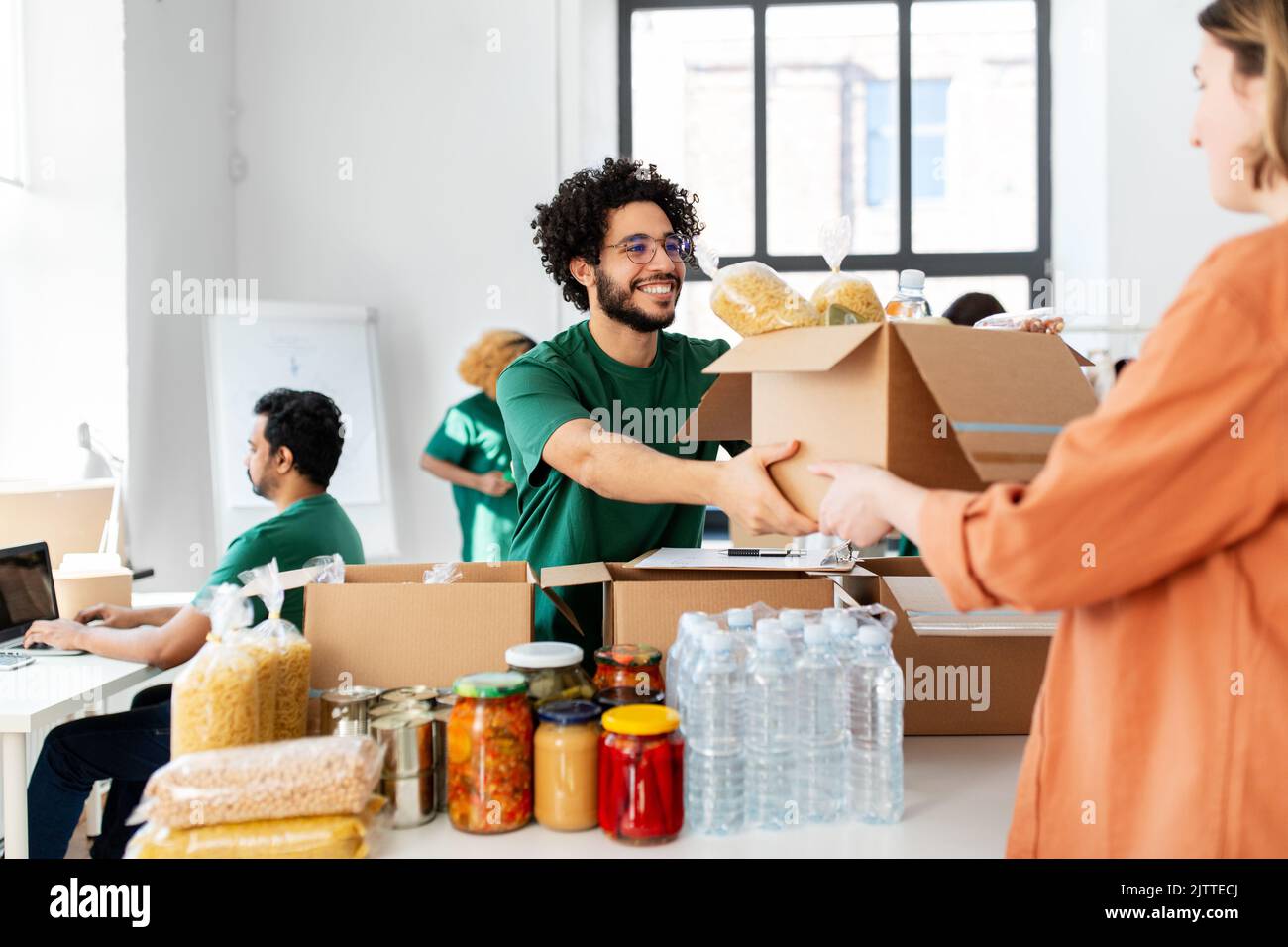 volunteer giving food at refugee assistance center Stock Photo - Alamy