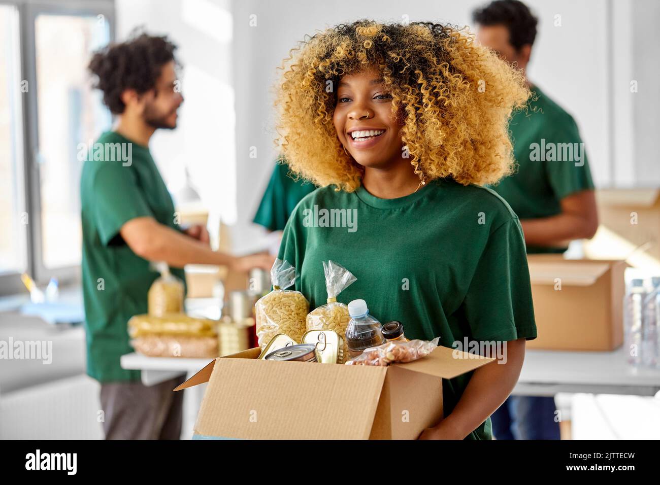 happy volunteers packing food in donation boxes Stock Photo - Alamy