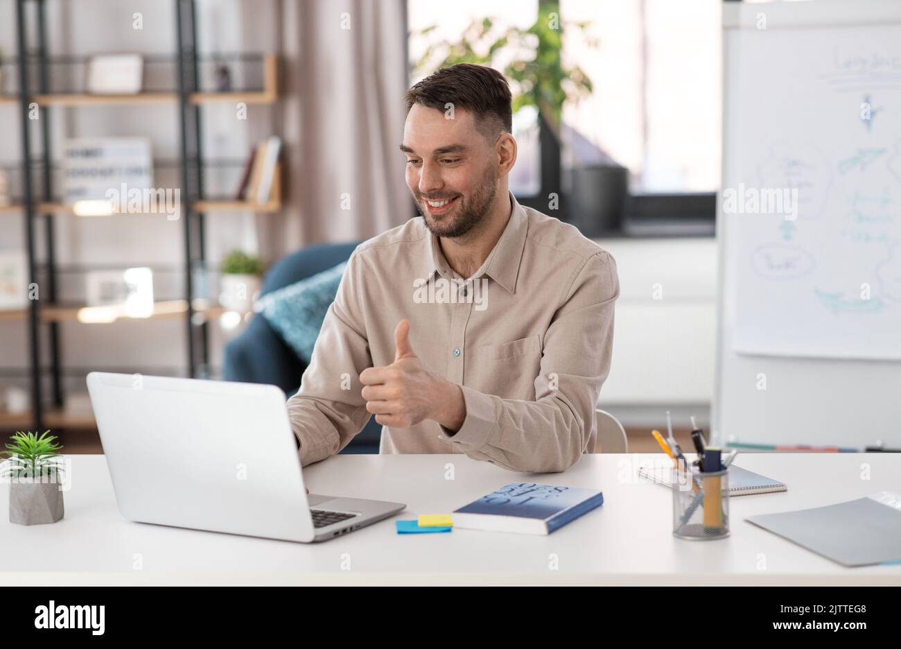 teacher with laptop having online class at home Stock Photo - Alamy