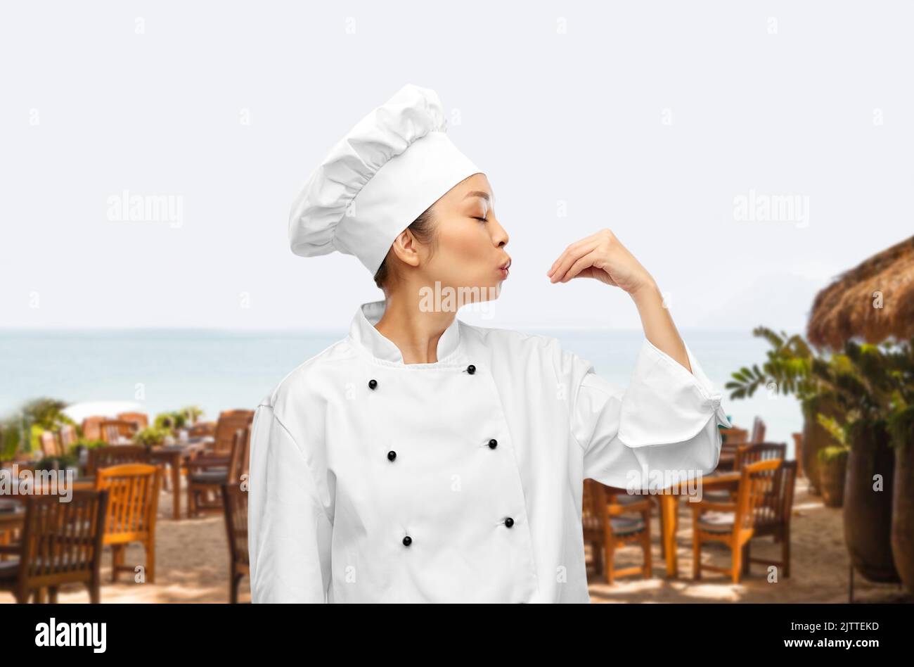 happy female chef showing gourmet sign Stock Photo - Alamy