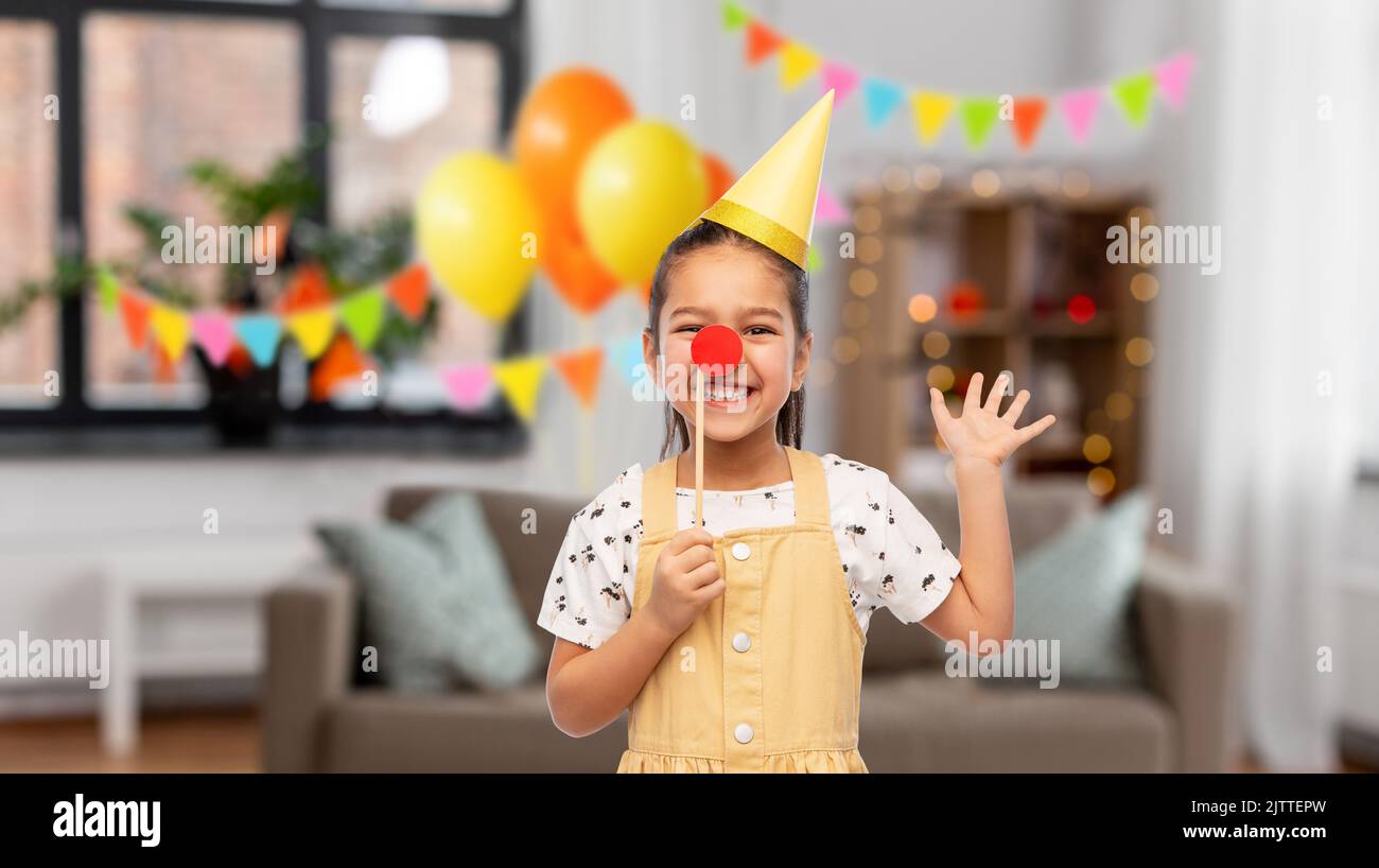 girl with red clown nose at birthday party at home Stock Photo - Alamy