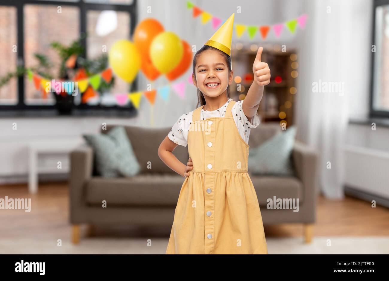 girl showing thumbs up at birthday party at home Stock Photo - Alamy
