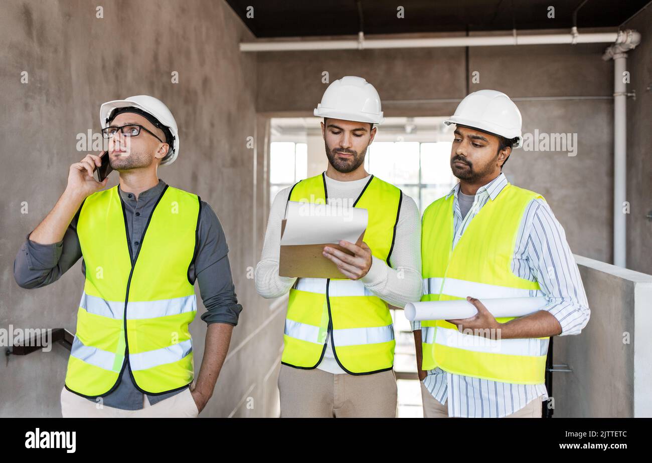 male architects in helmets working at office Stock Photo - Alamy