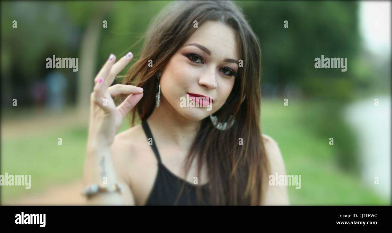 Doing Ok Sign With Hand Portrait Of Hispanic Latina Girl Looking To