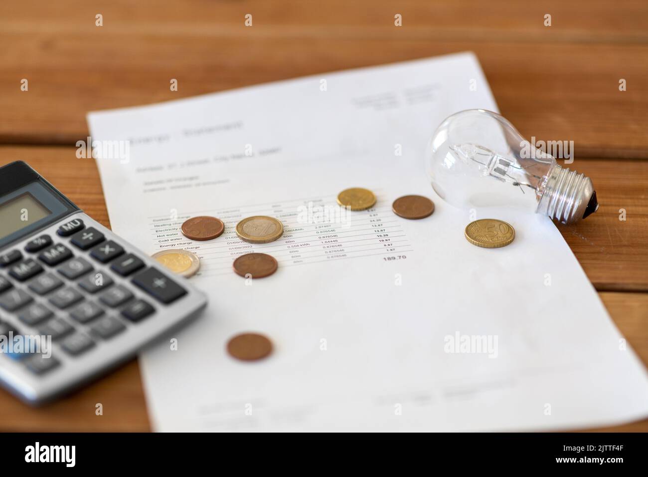 utility bill, calculator, money and lightbulb Stock Photo - Alamy