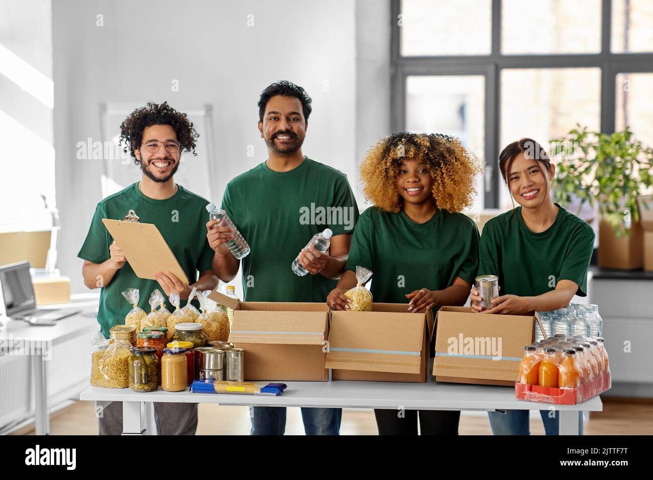 happy volunteers packing food in donation boxes Stock Photo - Alamy