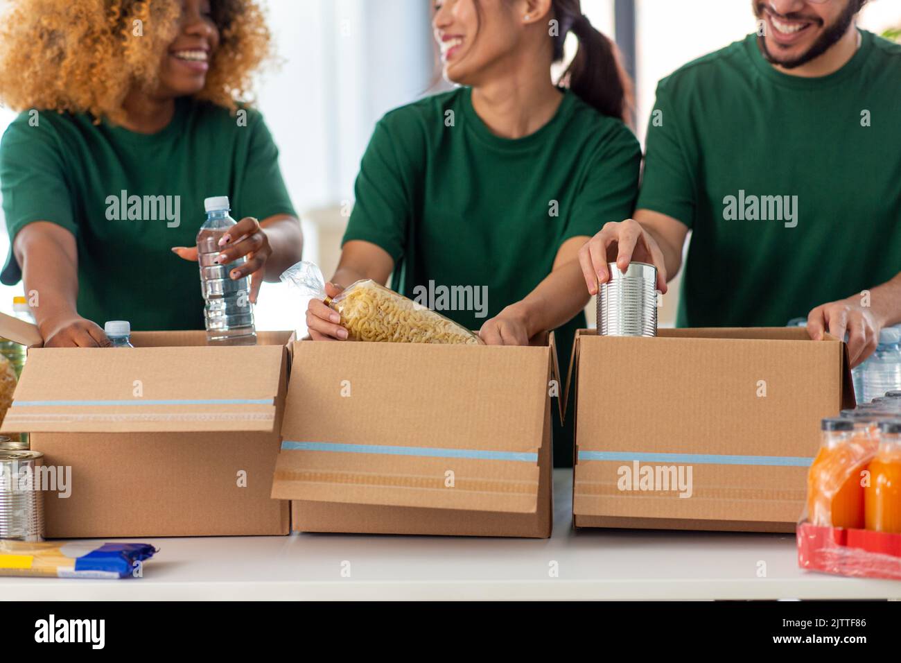happy volunteers packing food in donation boxes Stock Photo - Alamy