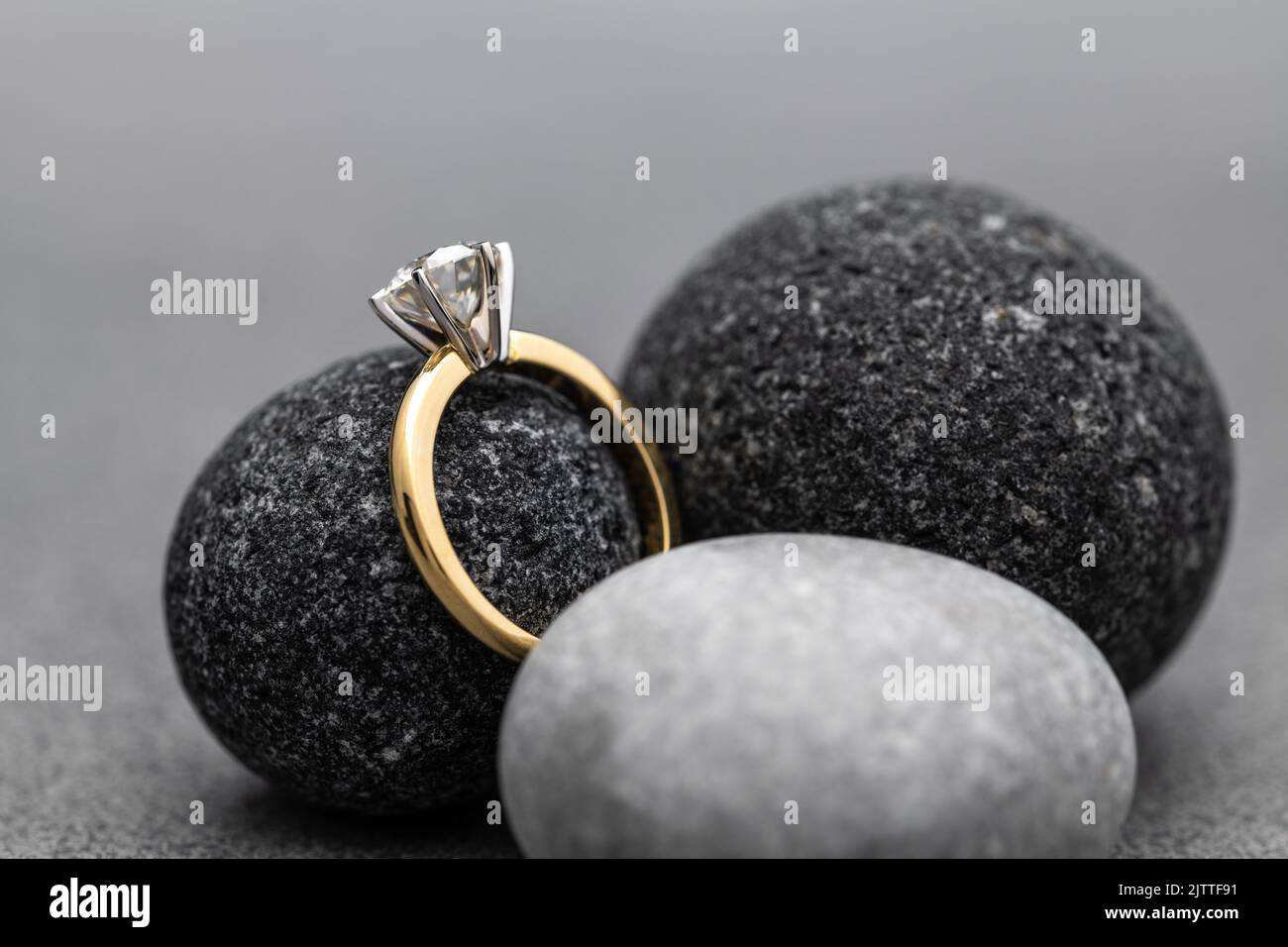 Classic Engagement Wedding Ring on Natural Stones Stock Photo - Alamy