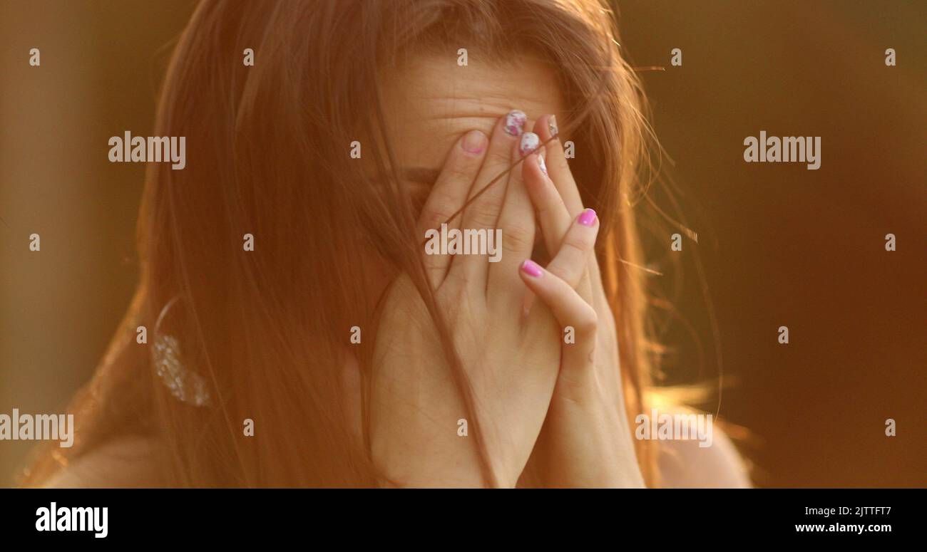 Millennial girl with hand in face feeling regret and sad Stock Photo ...