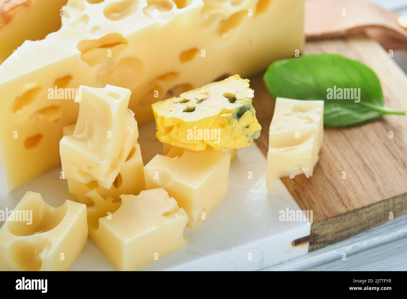 Piece of maasdam cheese and camembert, smoked cheese, blue cheese ...