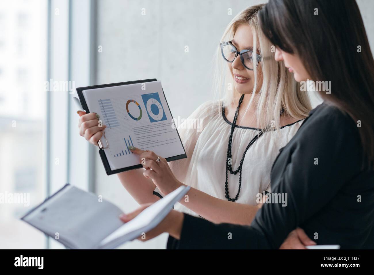 successful business women analytics report Stock Photo - Alamy