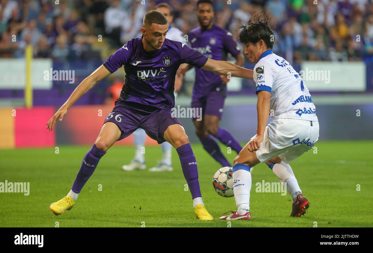 Anderlecht's Zeno Debast and Gent's Hyunseok Hong fight for the ball ...