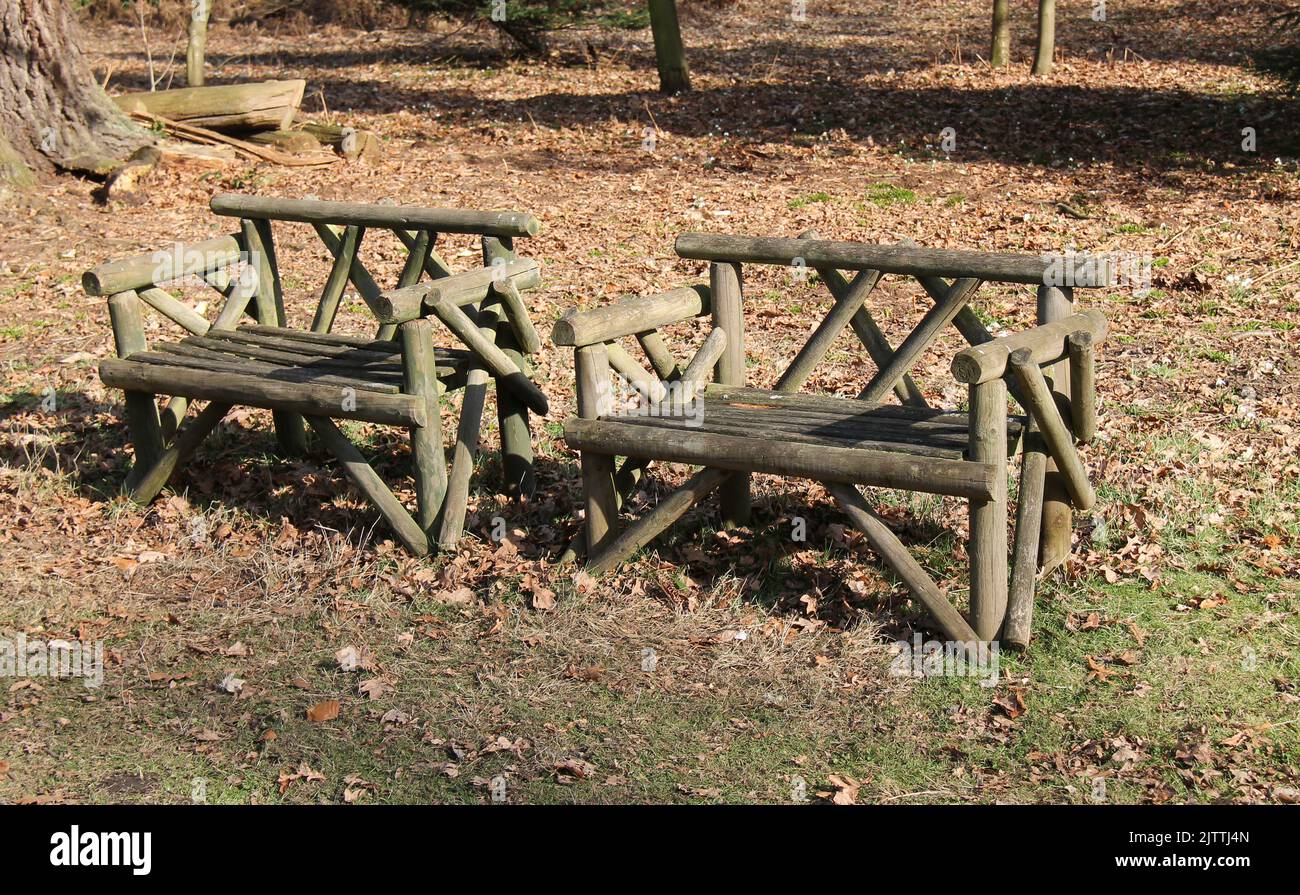 Two Rustic Wooden Seats in a Woodland Setting Stock Photo - Alamy