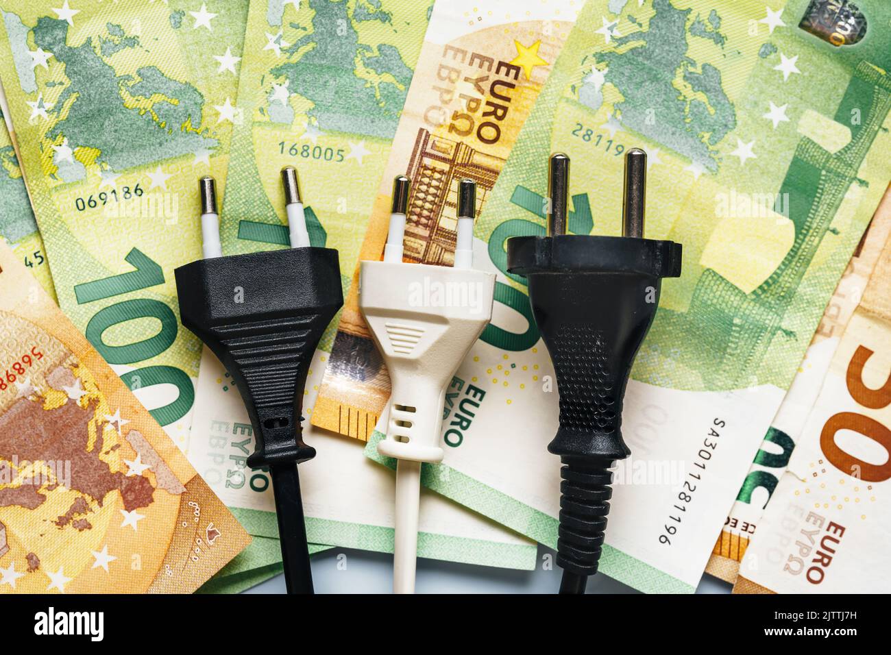 Electrical plug next to euro banknotes showing the drastical increase ...