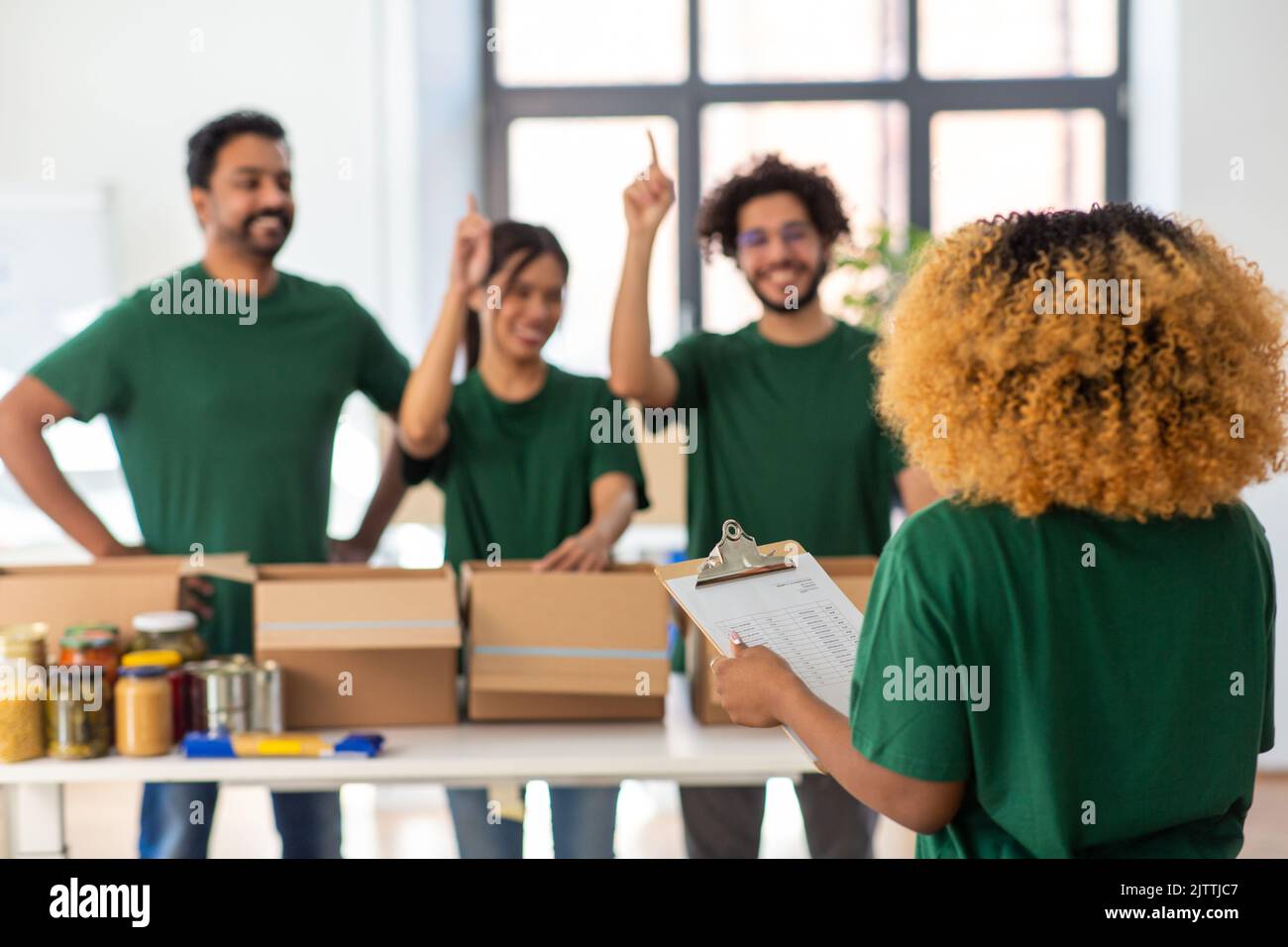 happy volunteers packing food in donation boxes Stock Photo - Alamy