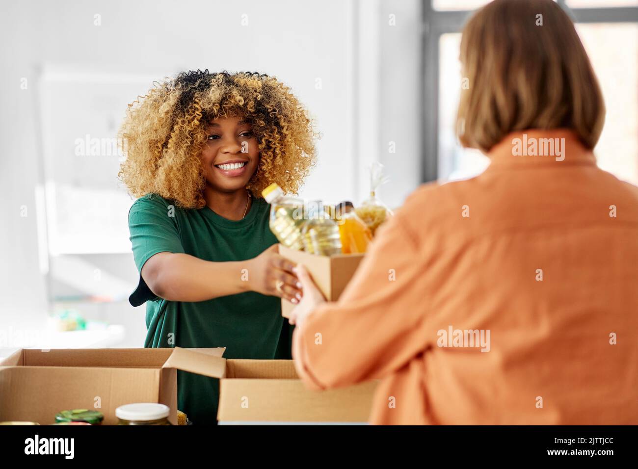 volunteer giving food at refugee assistance center Stock Photo - Alamy