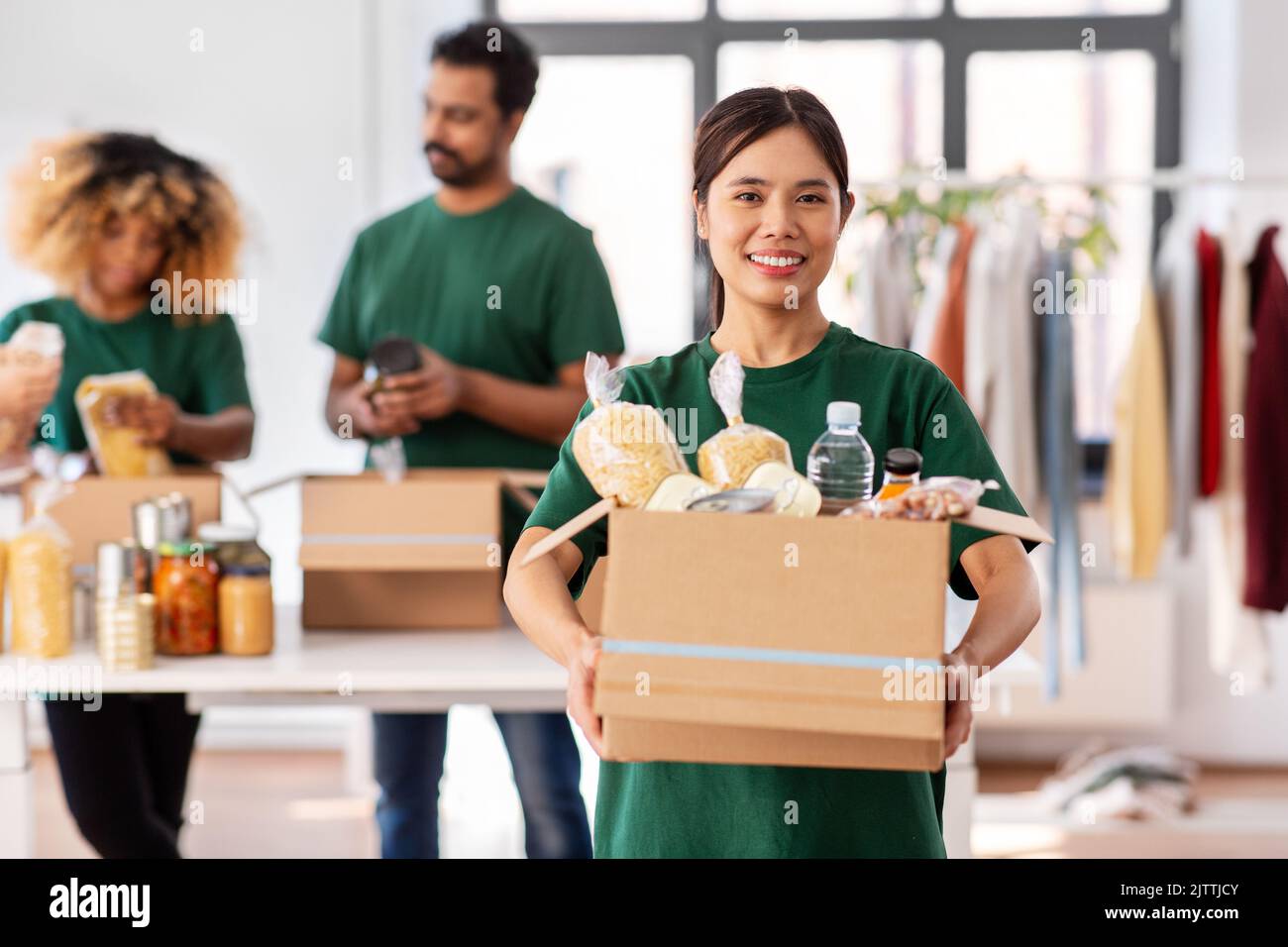 happy volunteers packing food in donation boxes Stock Photo - Alamy