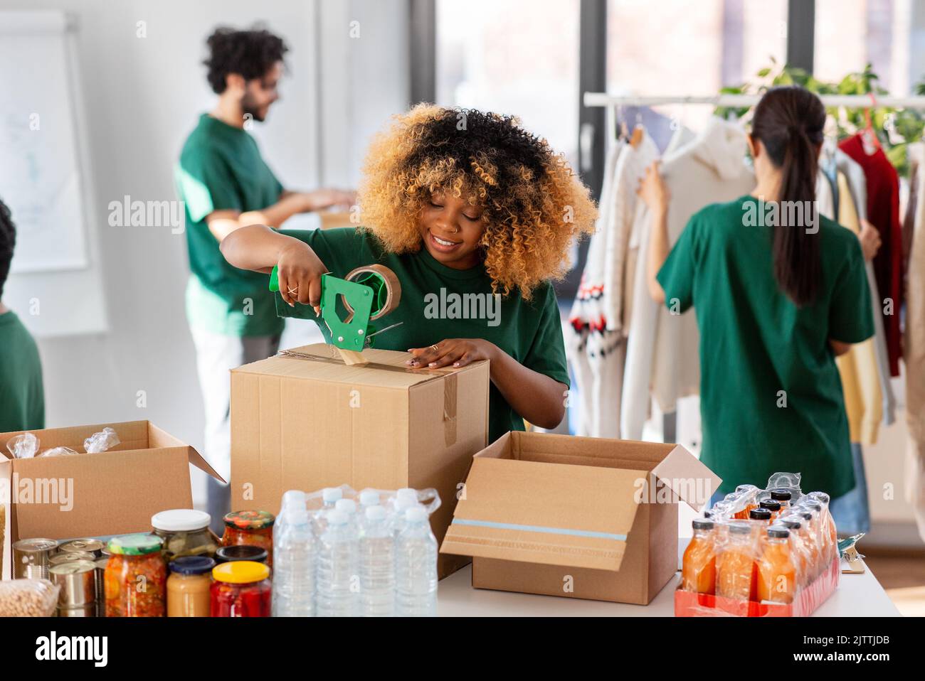 happy volunteers packing food in donation boxes Stock Photo - Alamy