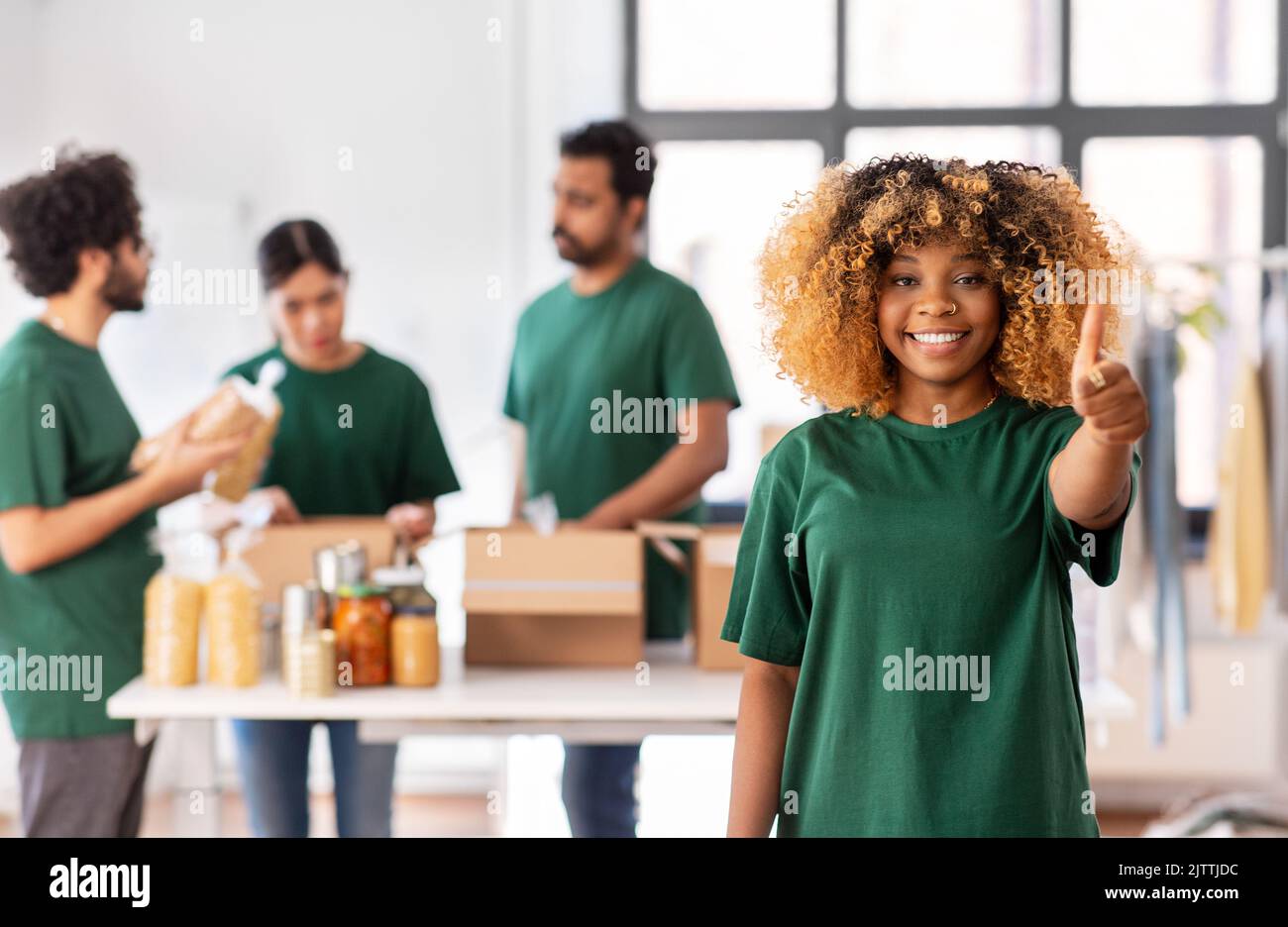 happy volunteers packing food in donation boxes Stock Photo - Alamy