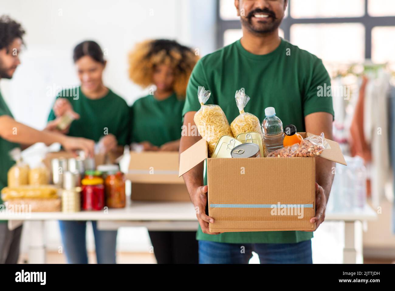 happy volunteers packing food in donation boxes Stock Photo - Alamy