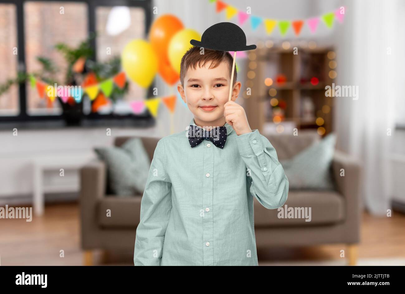 boy with birthday party props and bowler hat Stock Photo - Alamy