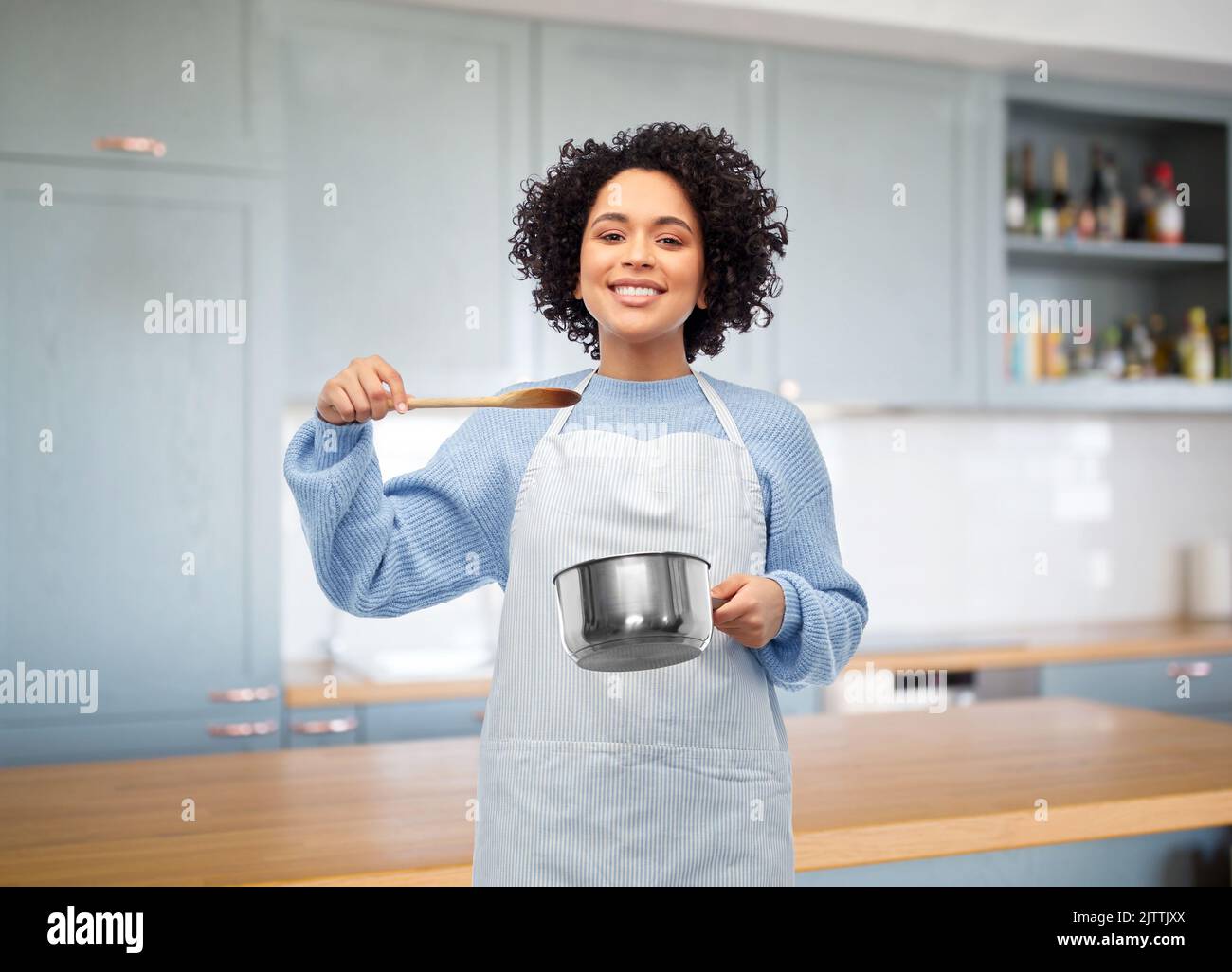 happy woman cooking food in saucepan in kitchen Stock Photo - Alamy