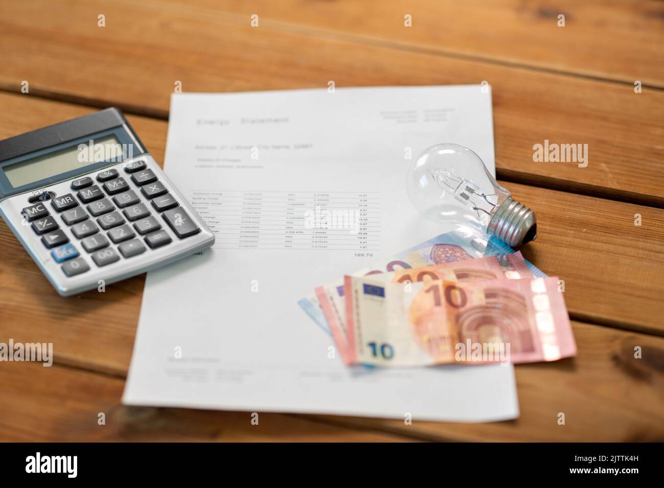 utility bill, calculator, money and lightbulb Stock Photo - Alamy