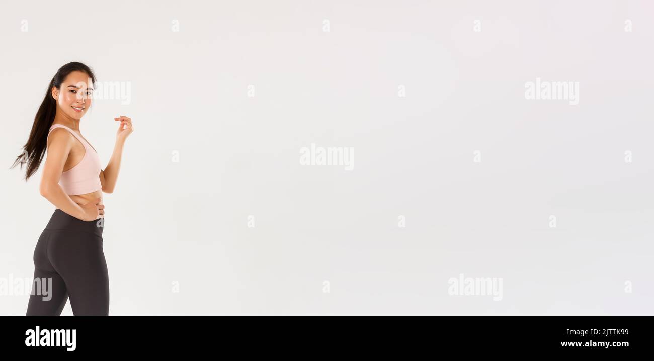 Full length profile portrait of sassy slim brunette asian girl doing ...