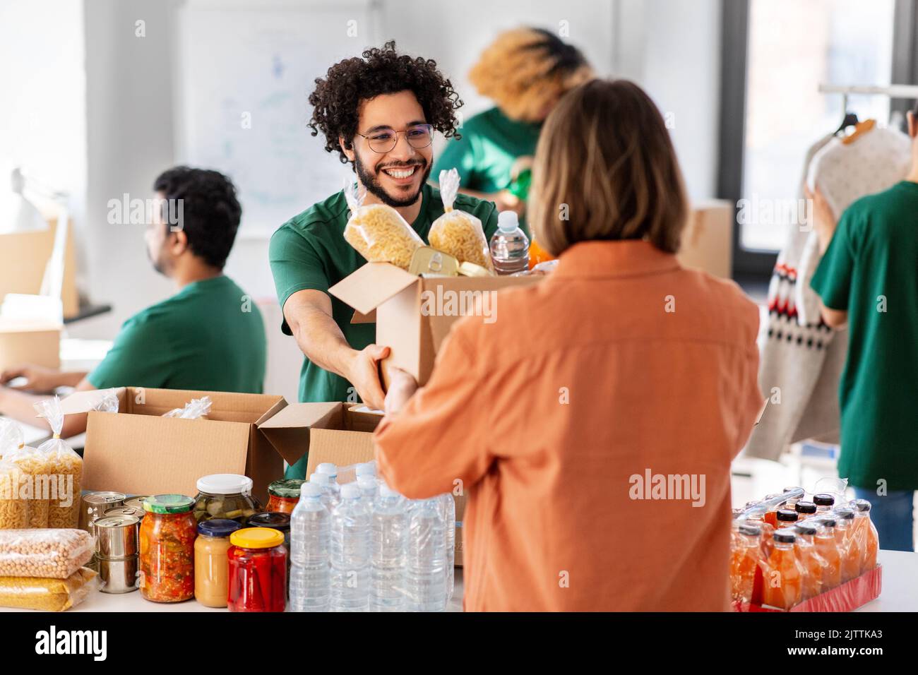 happy volunteers packing food in donation boxes Stock Photo - Alamy