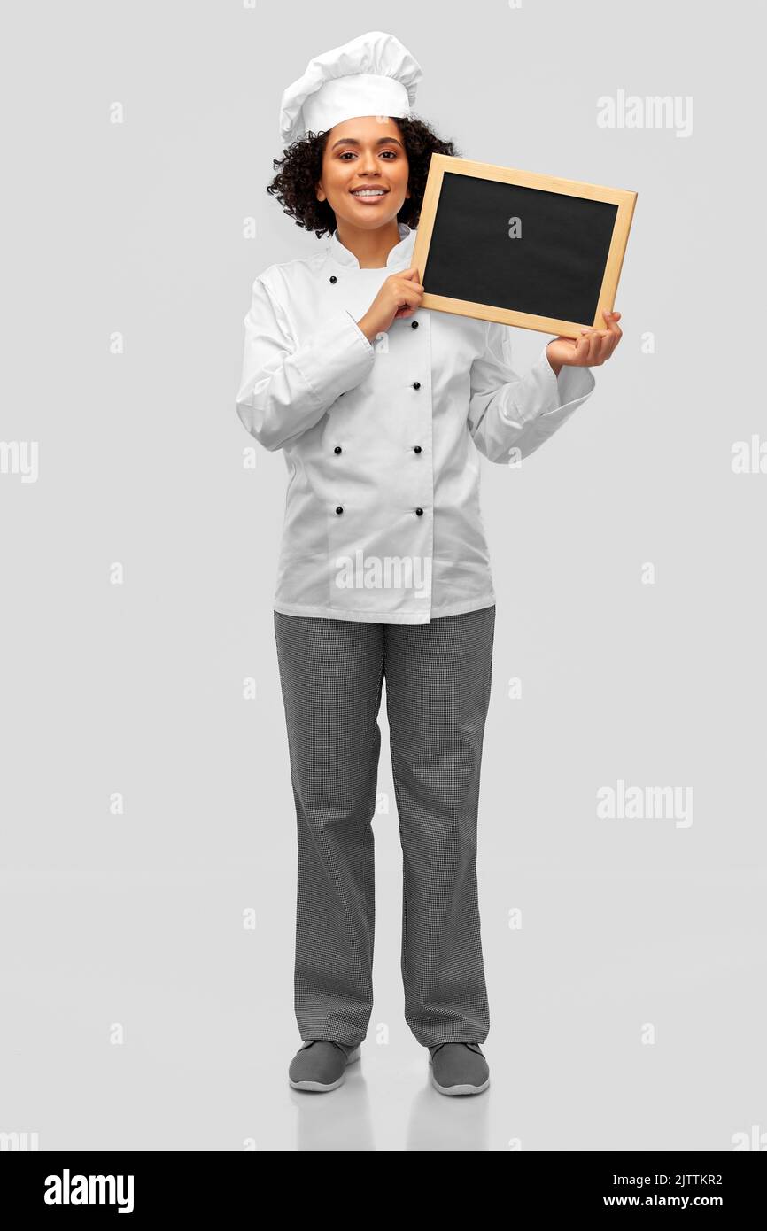 smiling female chef holding black chalkboard Stock Photo - Alamy