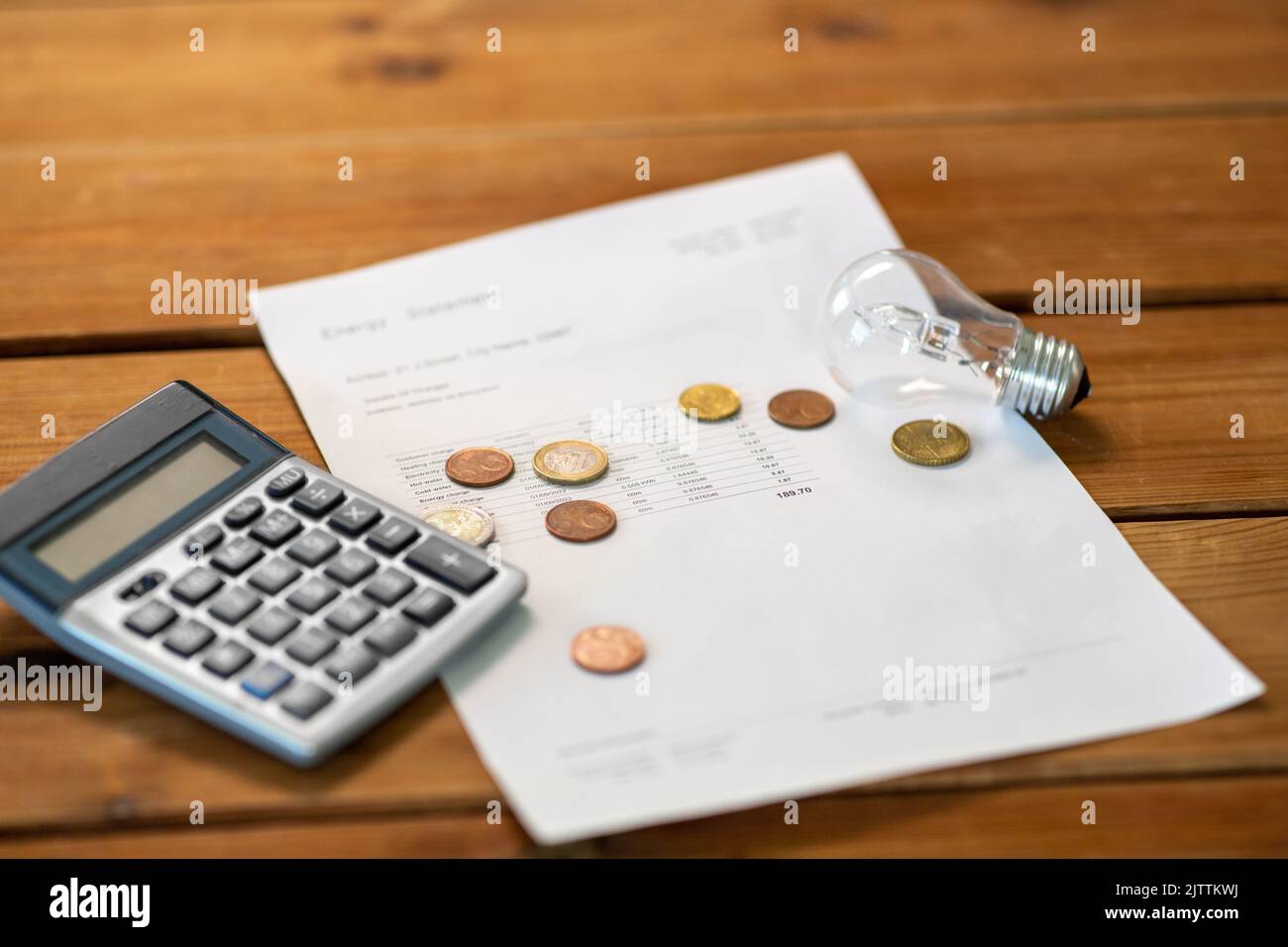 utility bill, calculator, money and lightbulb Stock Photo - Alamy
