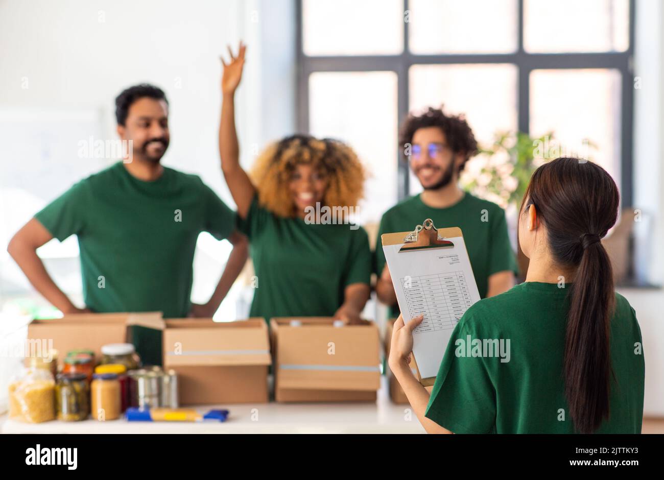 happy volunteers packing food in donation boxes Stock Photo - Alamy