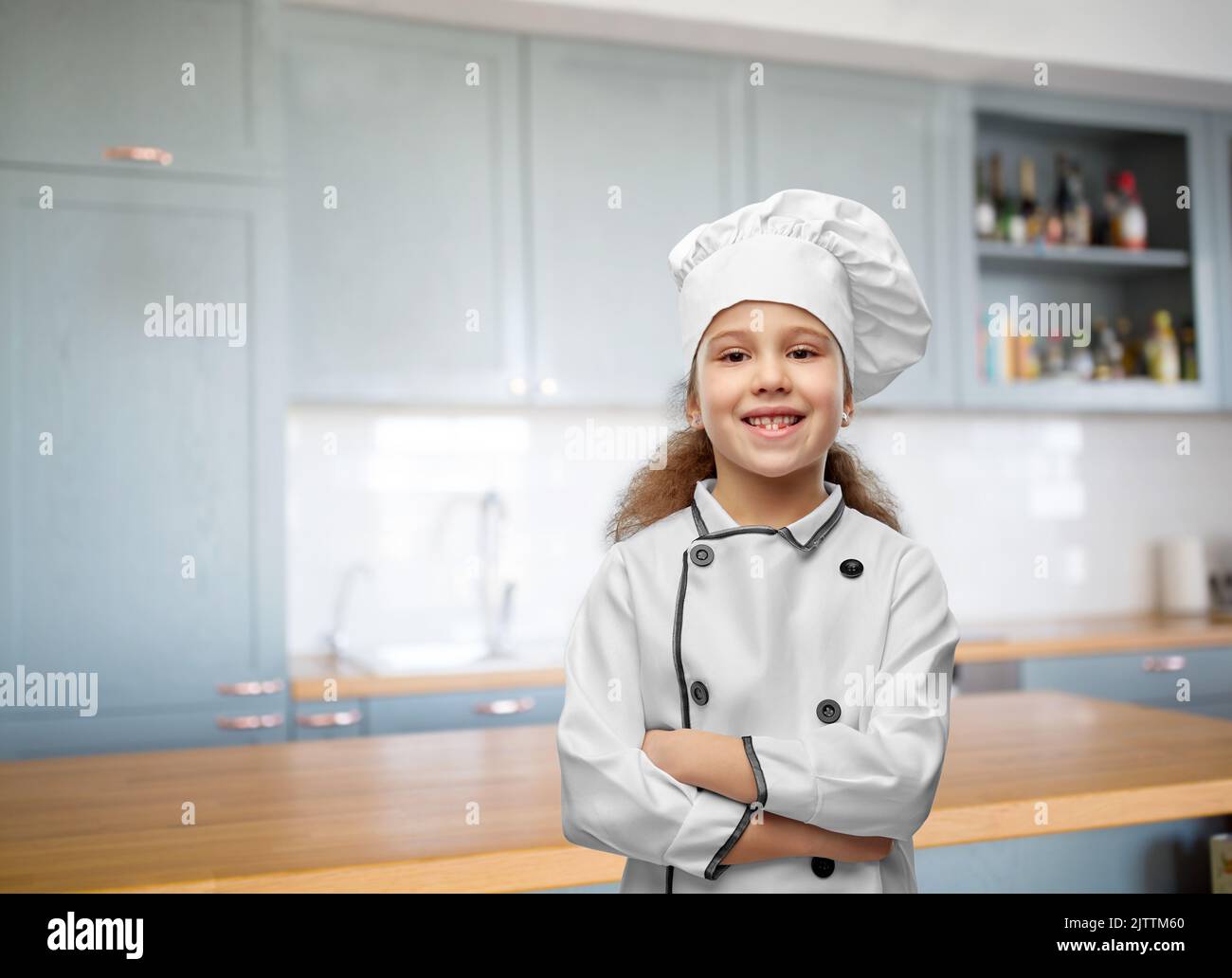 smiling little girl in chef's toque in kitchen Stock Photo - Alamy