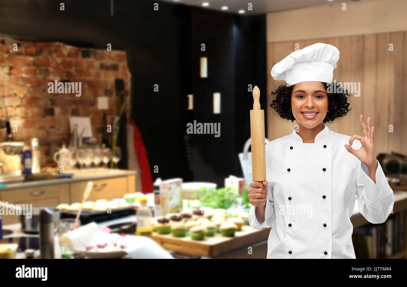 smiling female chef or baker with rolling pin Stock Photo - Alamy