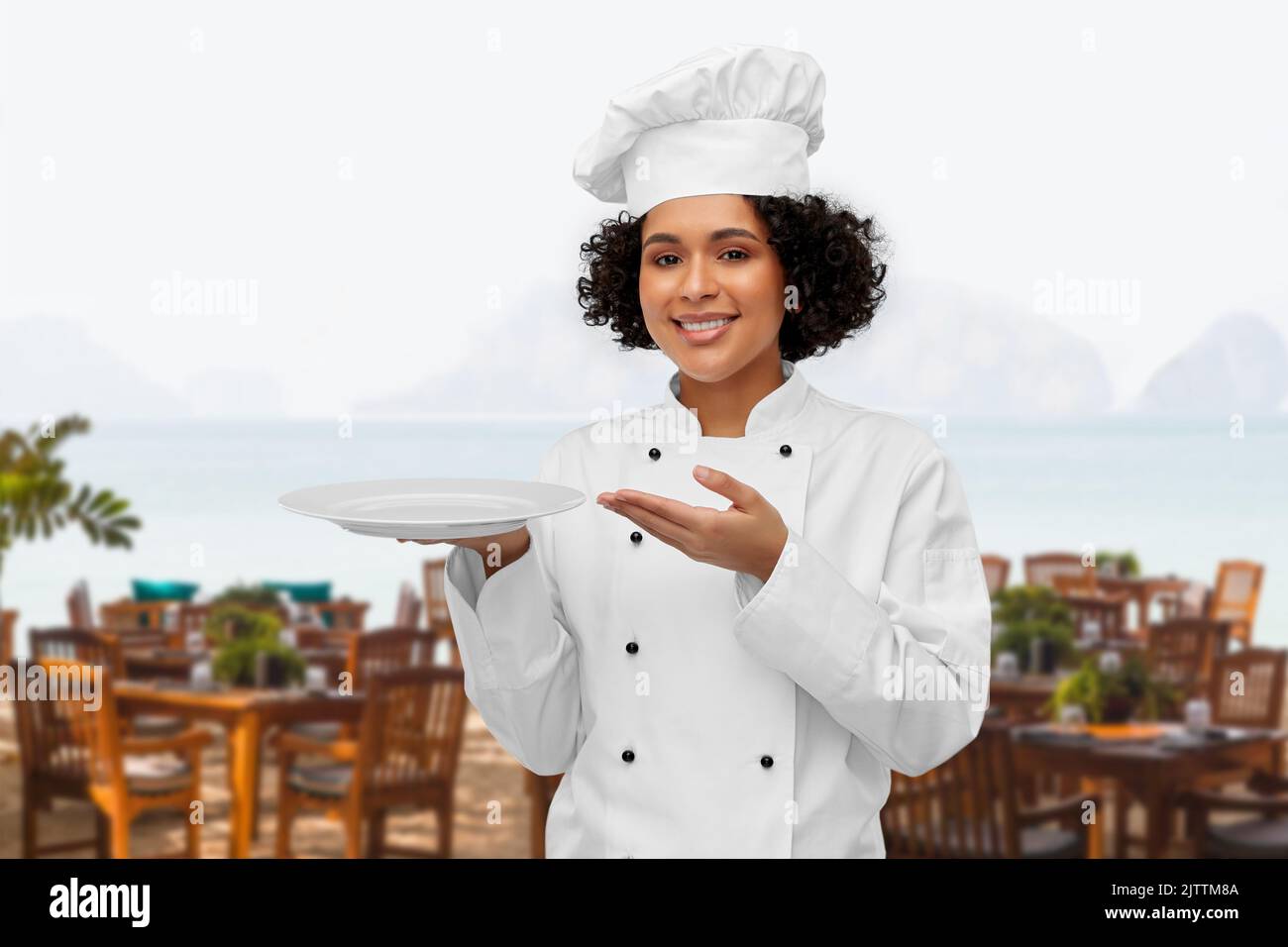 happy smiling female chef holding empty plate Stock Photo - Alamy