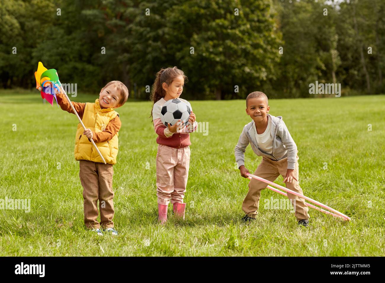 happy kids with pinwheel having fun at park Stock Photo - Alamy