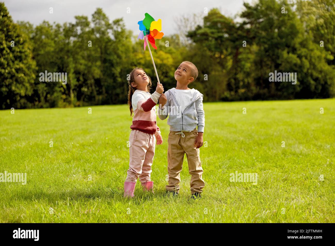 happy children playing with pinwheel at park Stock Photo - Alamy