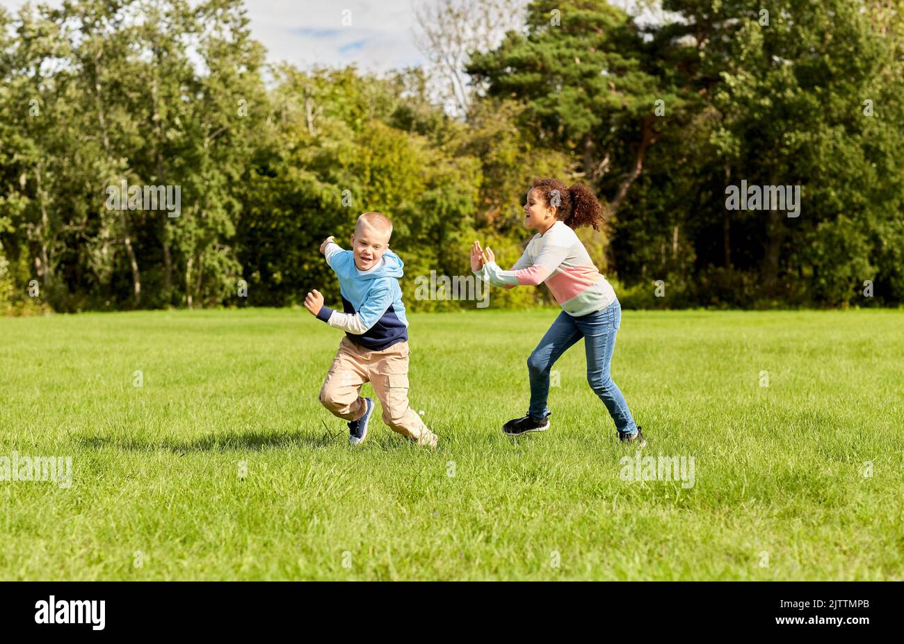 happy children playing and running at park Stock Photo - Alamy