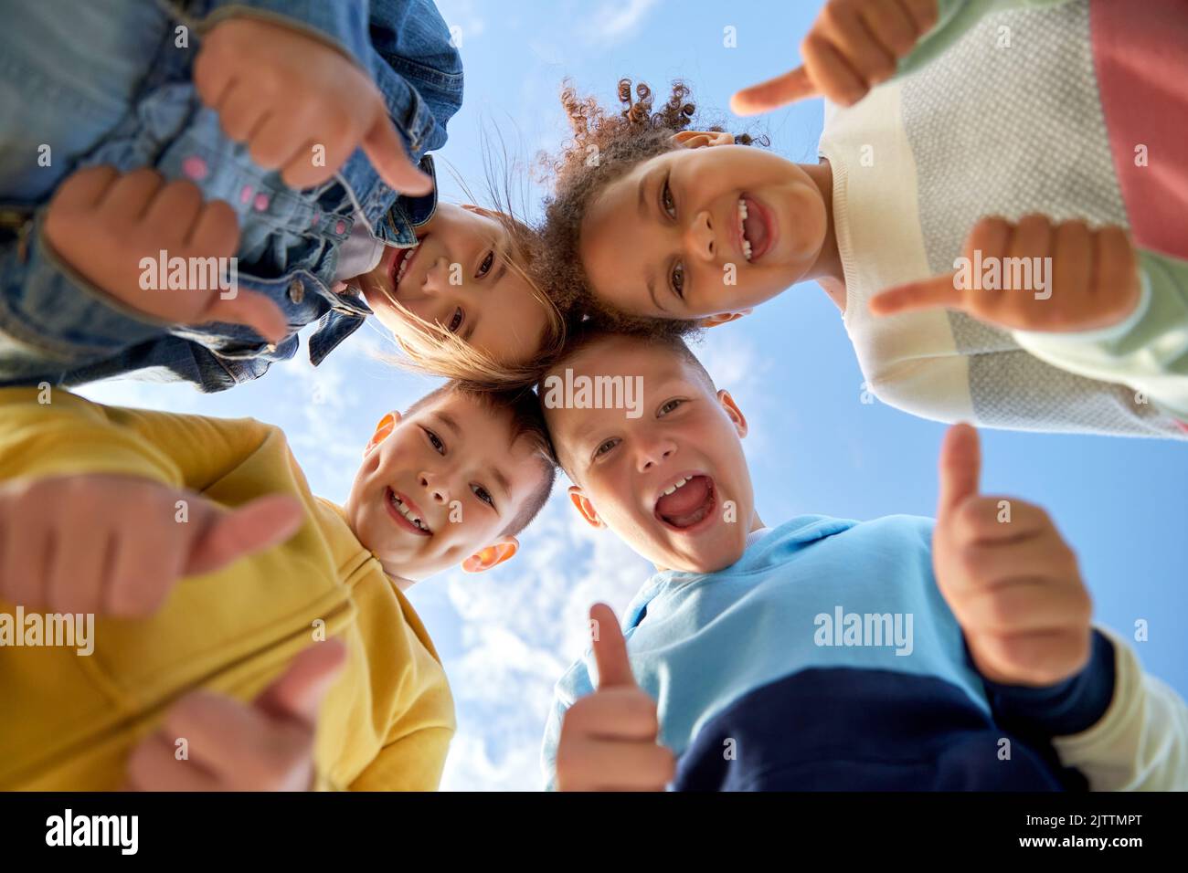happy children showing thumbs up outdoors Stock Photo - Alamy
