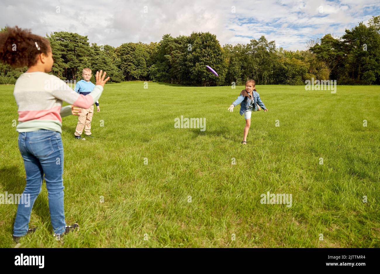 happy children playing with flying disc at park Stock Photo - Alamy