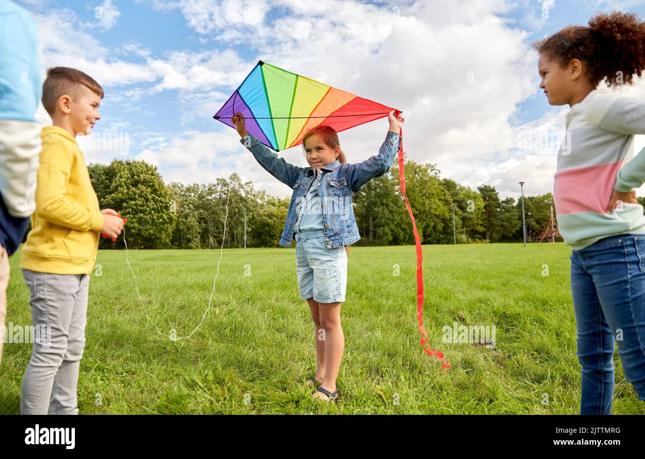 happy kids with kite playing at park Stock Photo - Alamy