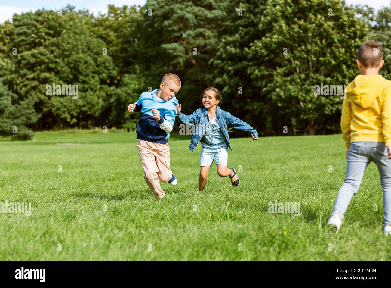 happy children playing and running at park Stock Photo - Alamy