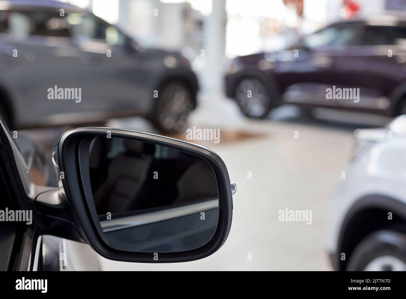 New unknown cars at dealer showroom. Themed blur background with blur ...