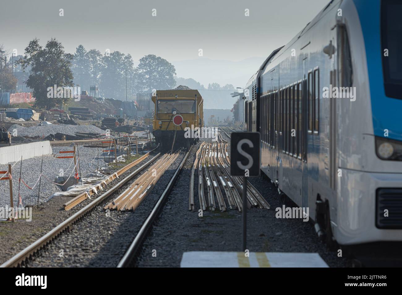 Train station is being renovated, trains stopped at a station and a ...