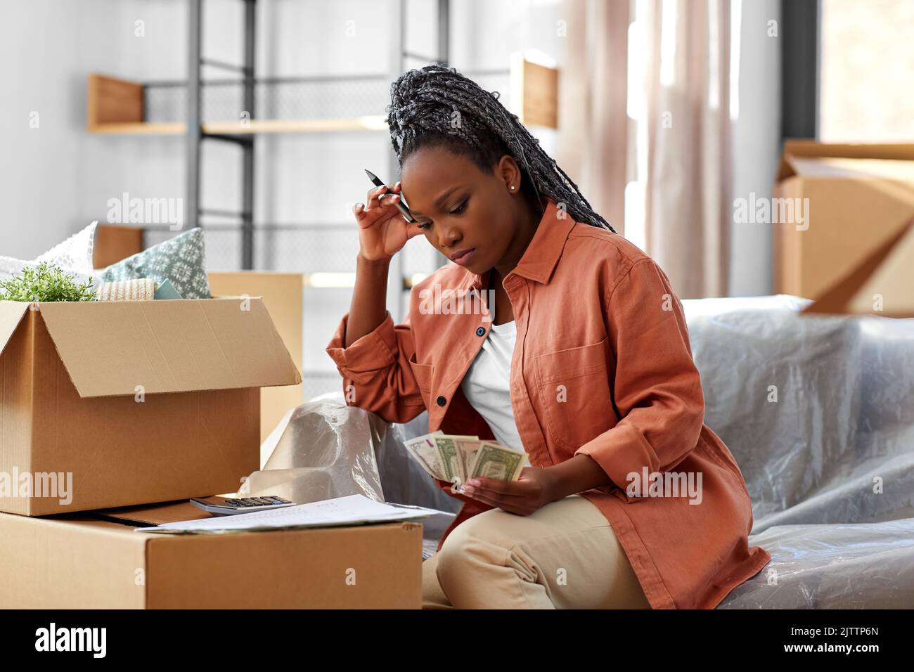 woman moving to new home and counting money Stock Photo - Alamy