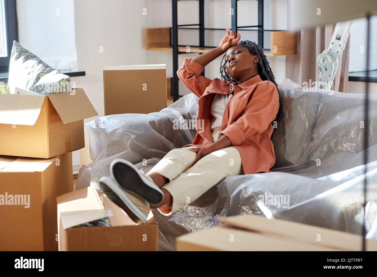 tired woman resting while moving to new home Stock Photo - Alamy