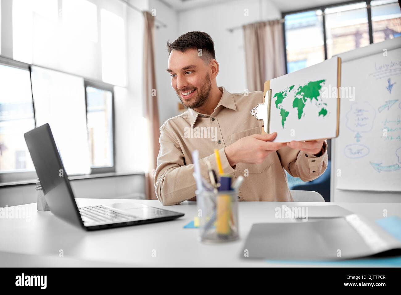 teacher with world map having online class at home Stock Photo - Alamy