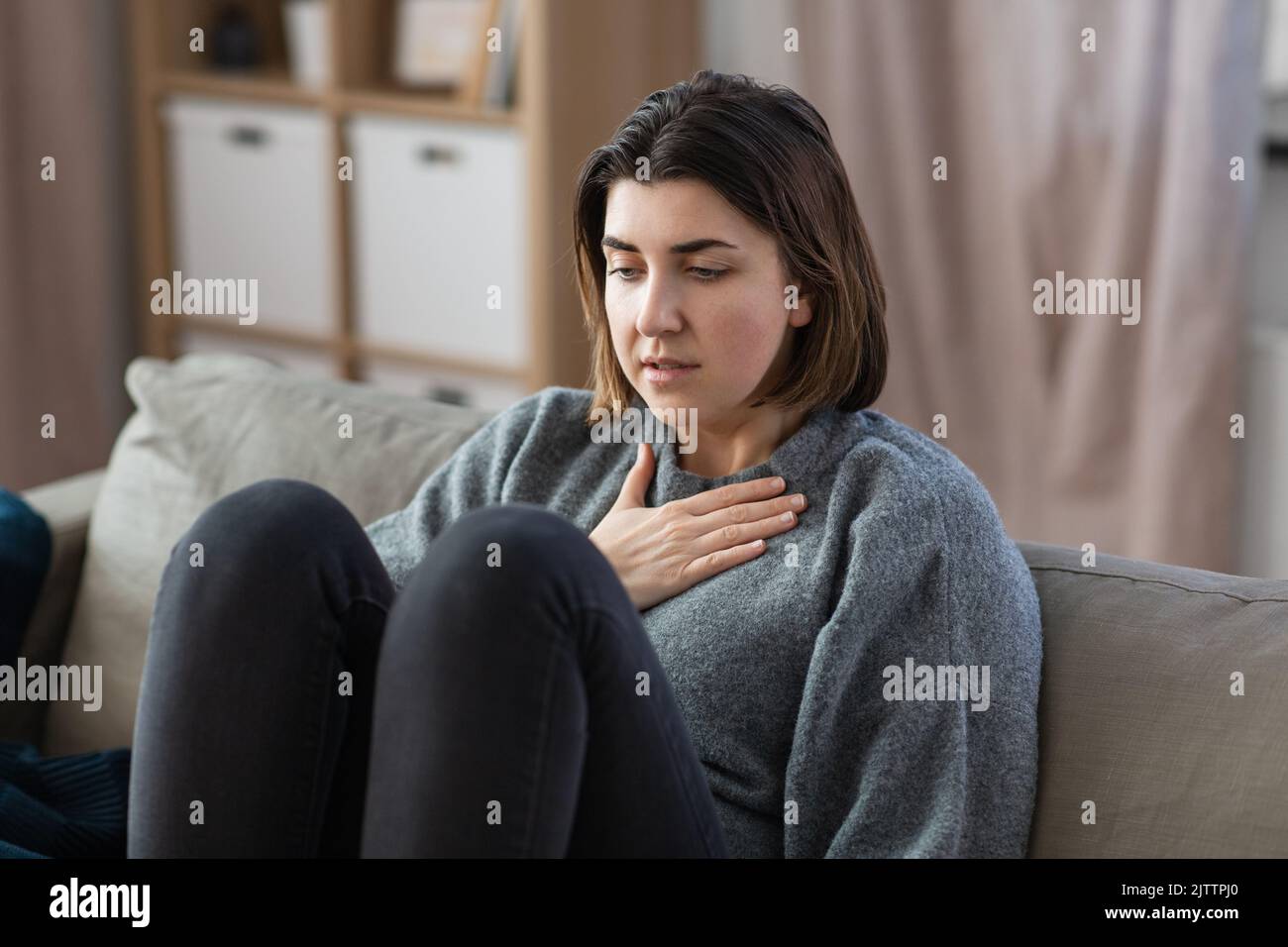 sad woman having panic attack at home Stock Photo - Alamy