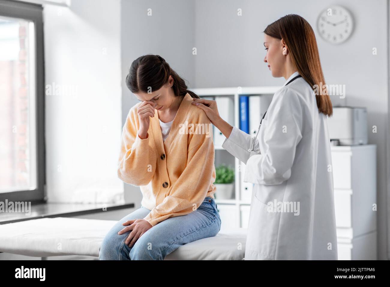 female doctor comforting sad woman at hospital Stock Photo - Alamy